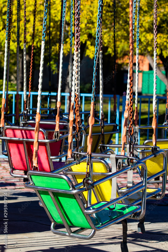 Empty carousel metal seat. Amusement park concept in a city park. Sunny ...