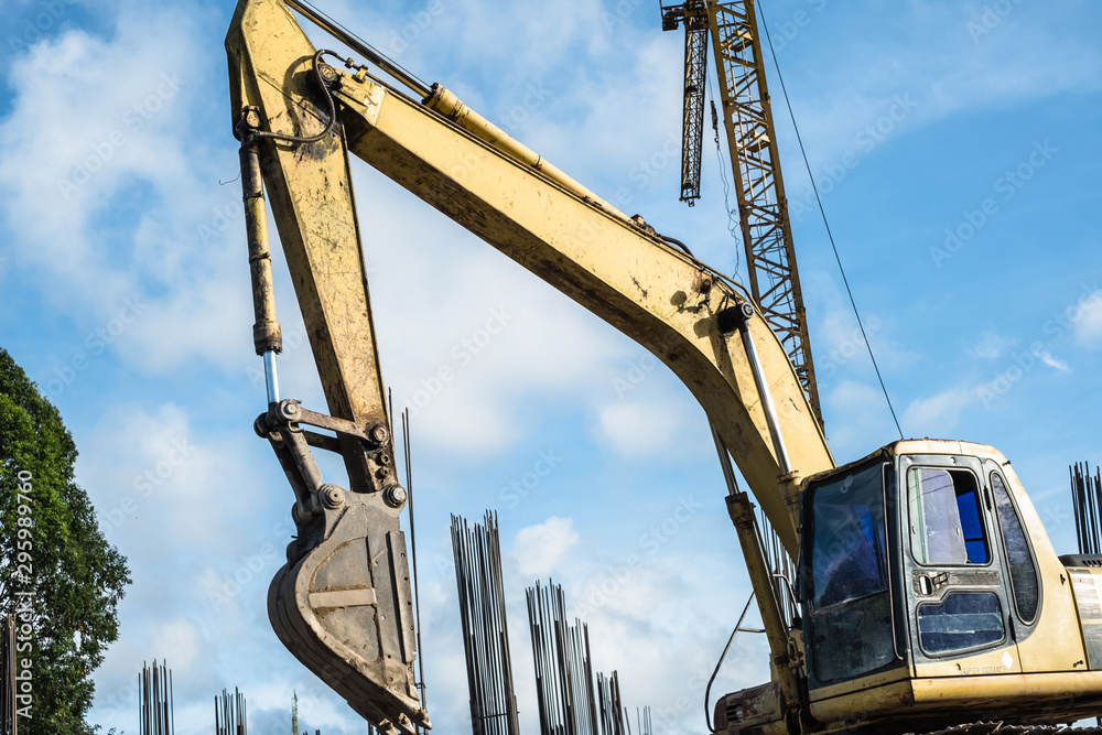 Old yellow backhoe or excavator work digging soil at new building ...