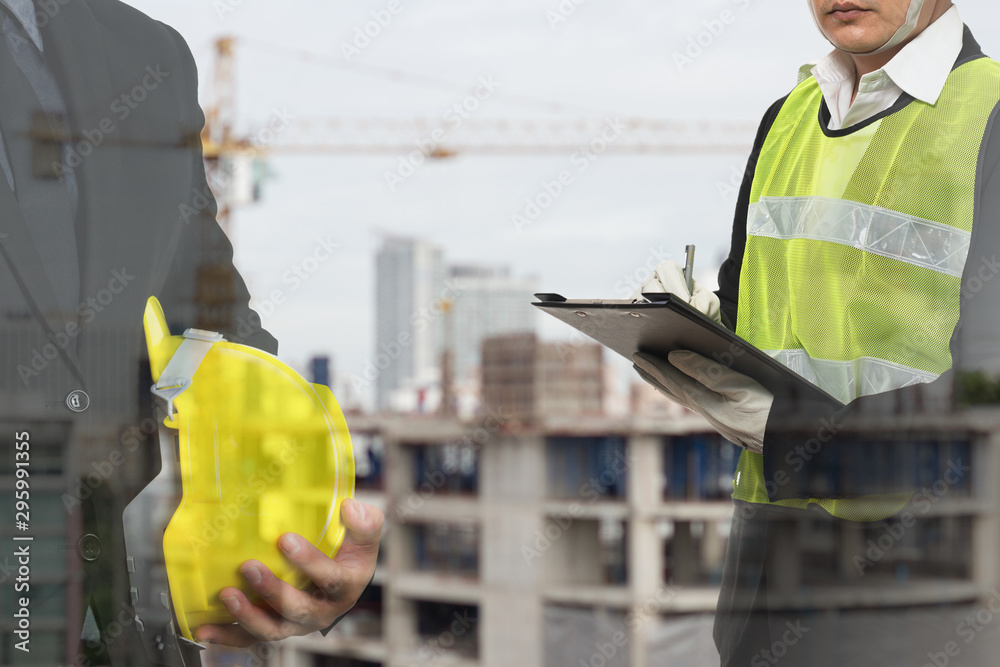 2 male occupational health and safety officer inside construction site ...