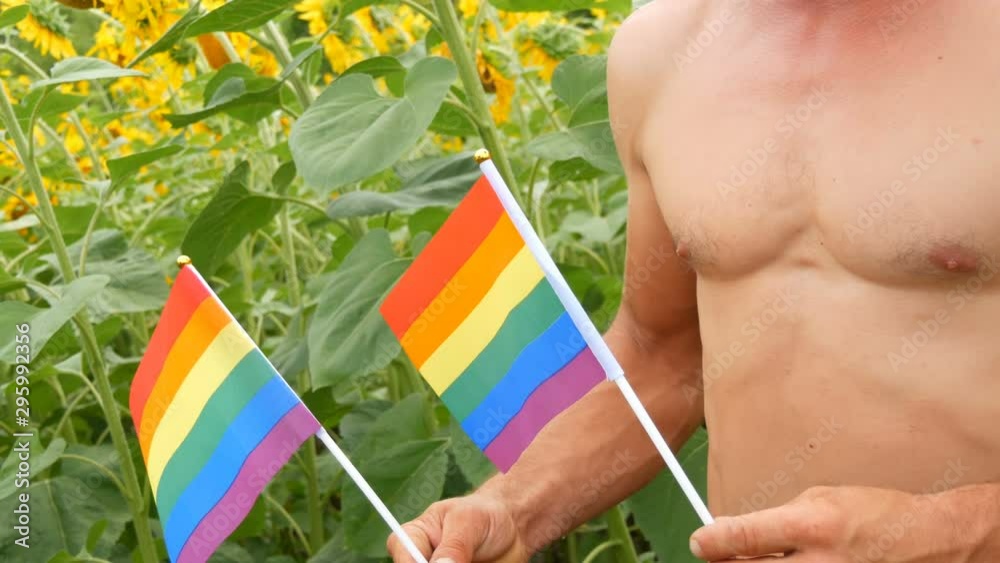 Beautiful body of a young athletic man with beautiful muscles holds a ...