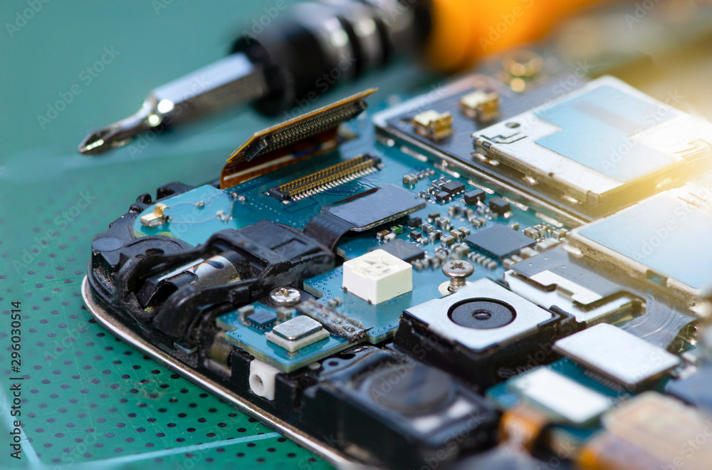 Closeup image of motherboard of mobile smart phone and screwdriver ...