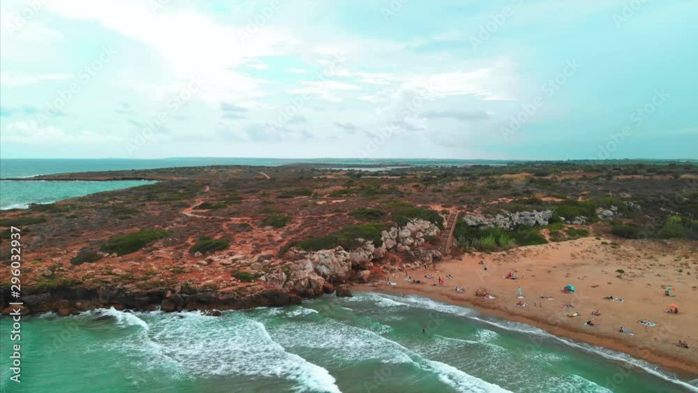 AERIAL DOLLY IN: Drone flying over Calamosche beach, in the Vendicari ...