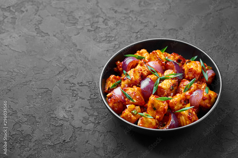 Schezwan Paneer in black bowl at dark slate background. Schezwan Paneer ...