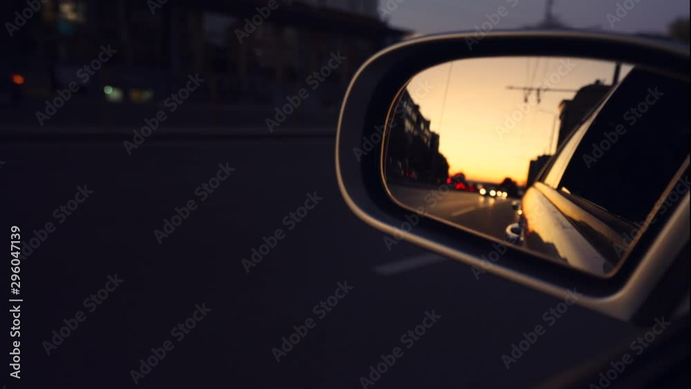 4k time lapse, side mirror of a car, evening time. passing cars ...
