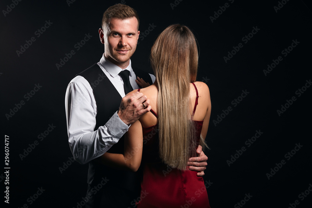 awesome man in fashion formal clothes helping woman to take off her ...