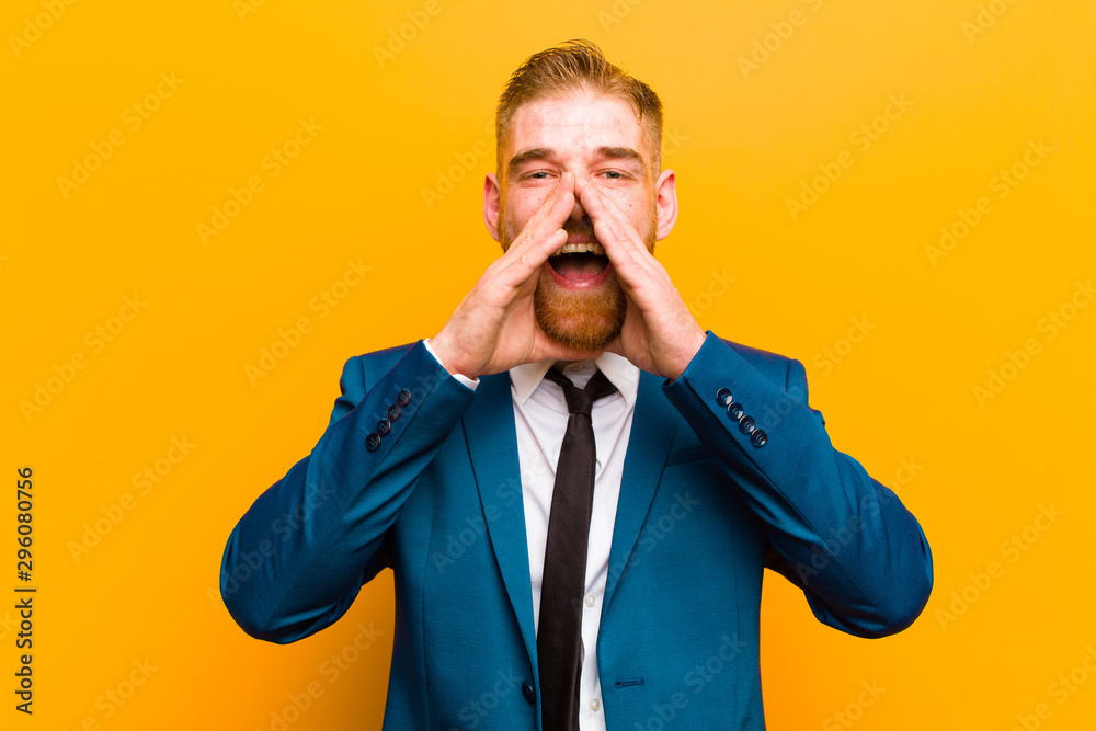 young red head businessman feeling happy, excited and positive, giving ...
