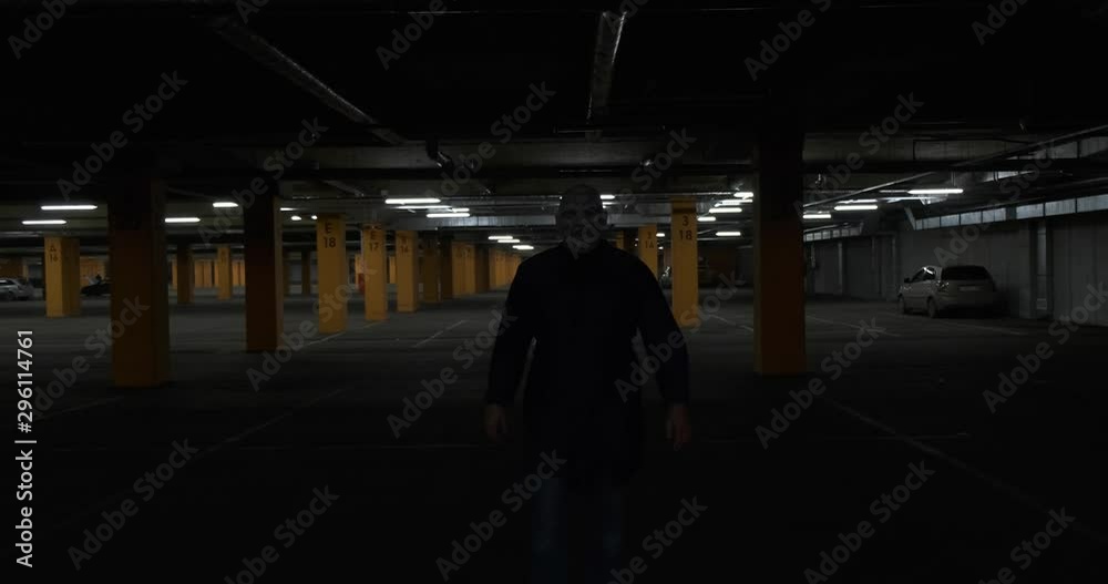 Camera on cart slowly moves away from man in scary halloween costume of ...