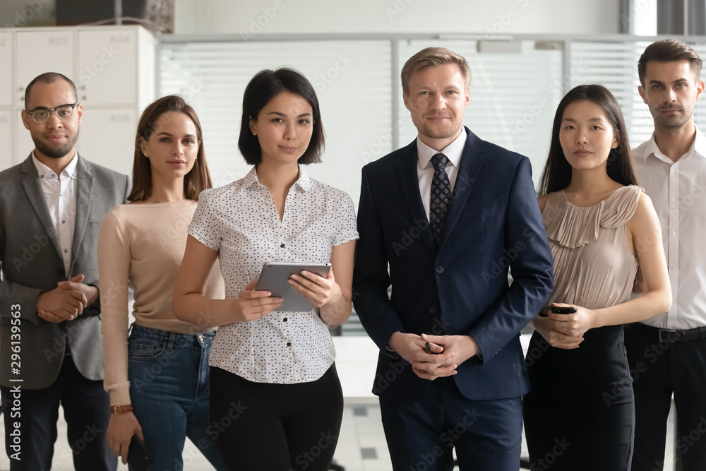Portrait of successful diverse employees team standing in office Stock ...