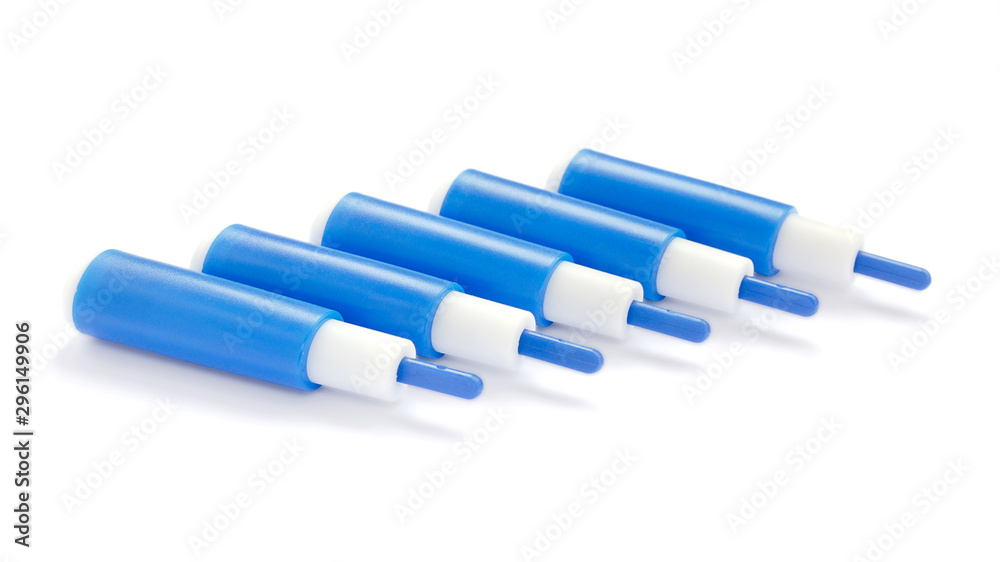 Blue lancets on a white background. Stack of blue lancets for a ...