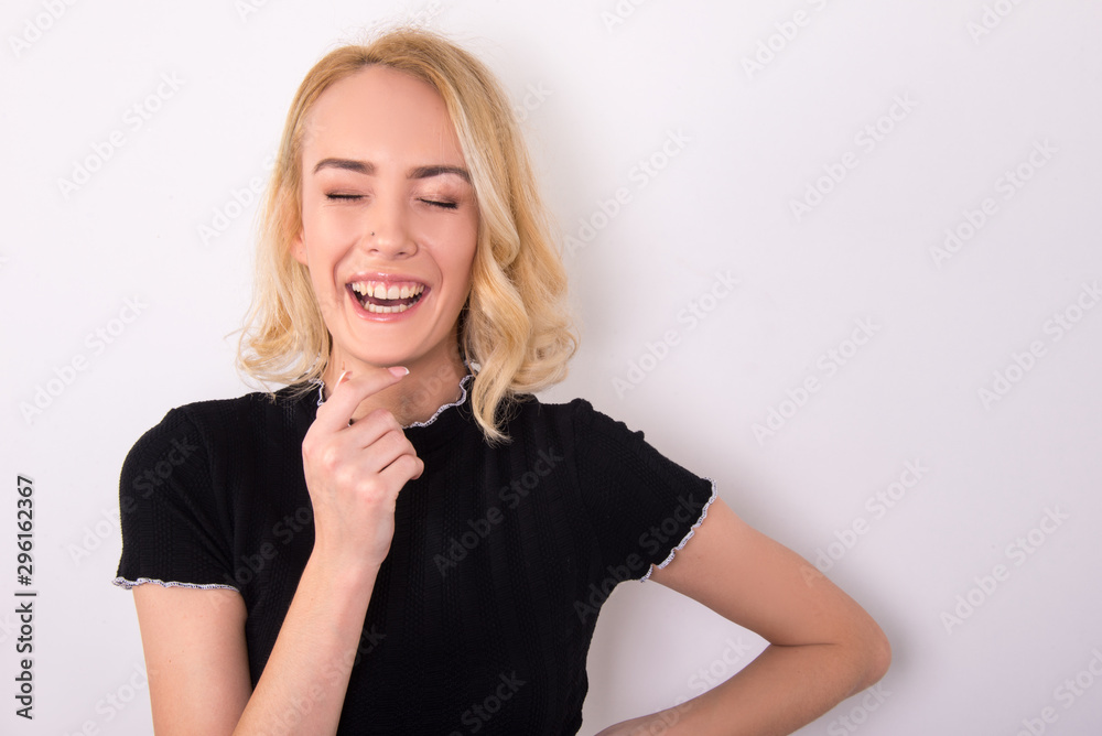 Smiling girl, blonde young woman, model in studio isolated on white ...