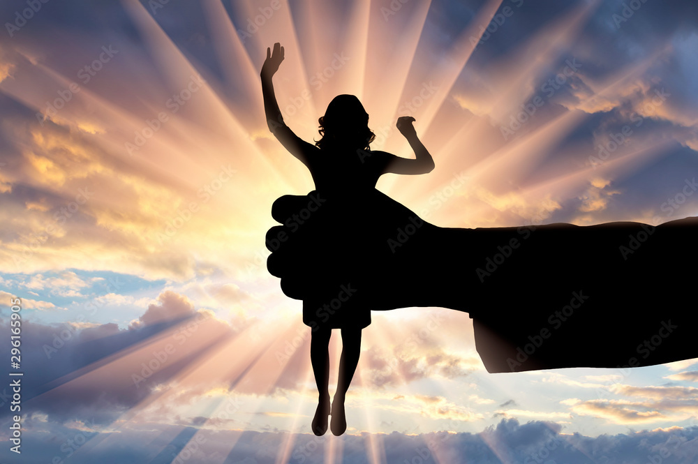 Bullying. Silhouette of a man’s hand holds a woman in a fist Stock ...