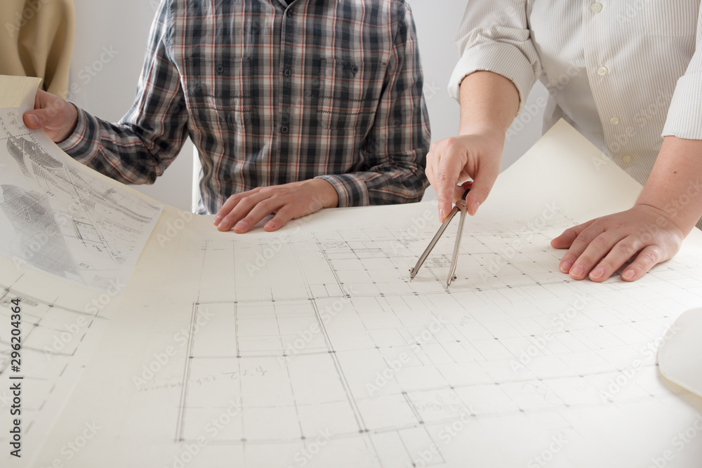 Architects working on blueprint, real estate project. Architect ...