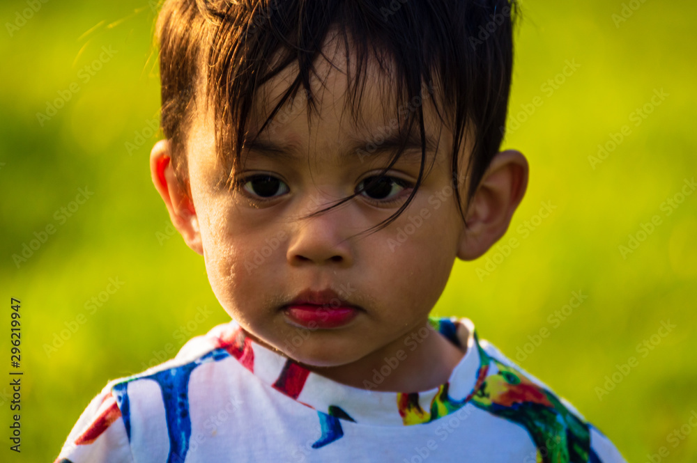 Cute Mexican American boy child is playing in a park in the city. Stock ...