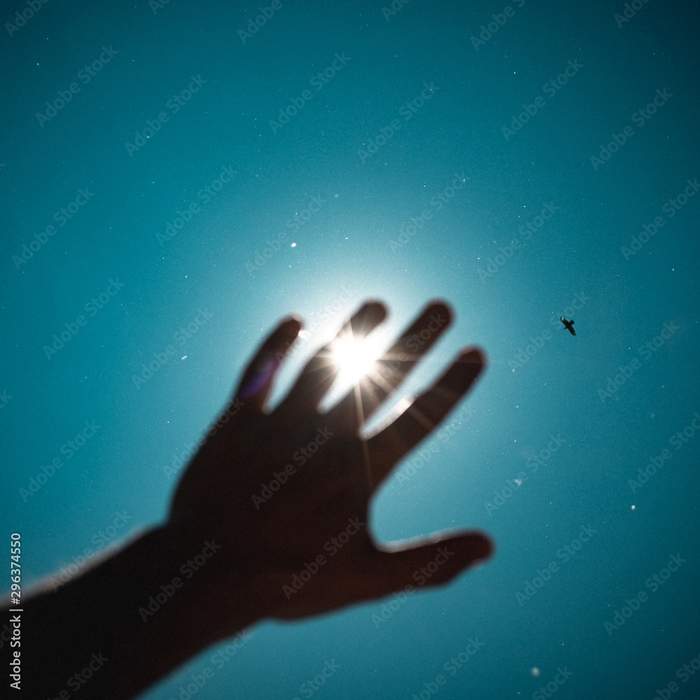 Close up of sun seen through man's hand 스톡 사진 | Adobe Stock