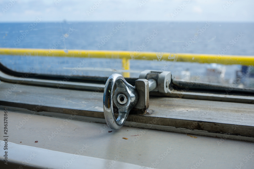 Locking srew for water tight window of a construction barge at oil ...