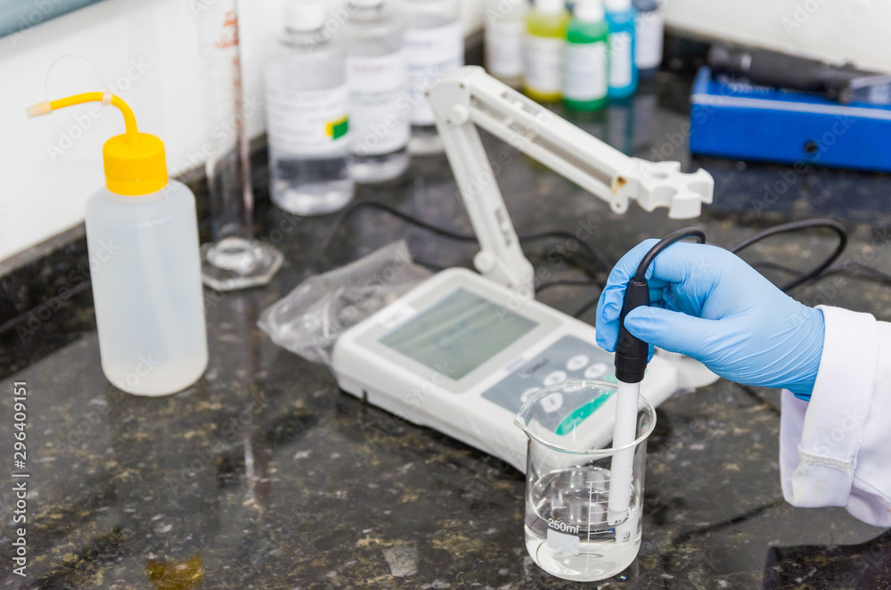 Woman hands performing pH test on pH meter electronic instrument Stock ...
