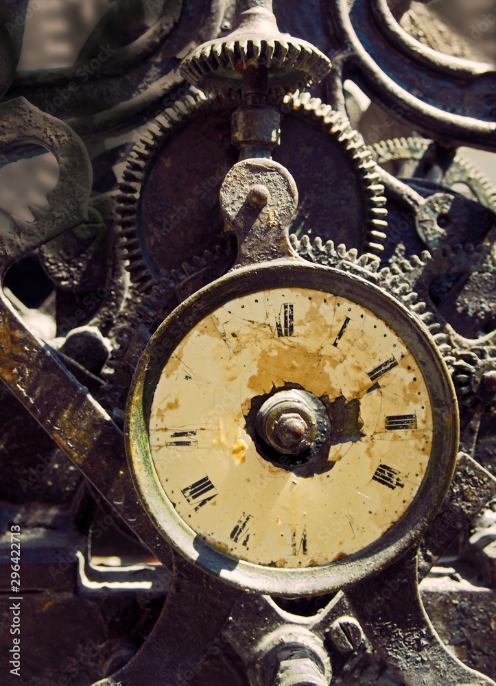 ancient rusty iron clock with weathered face and exposed complex ...