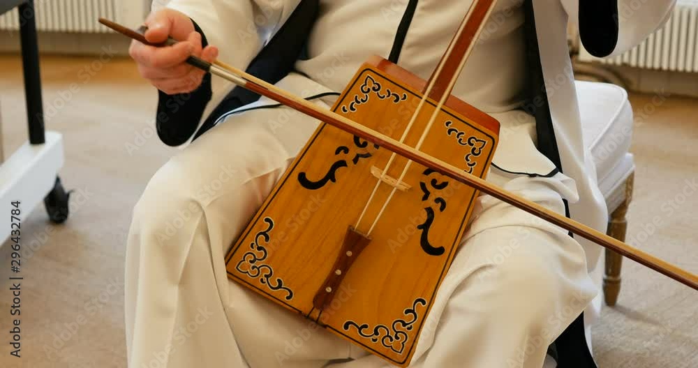 Professional Caucasian impressive musician playing matou qin, chinese ...
