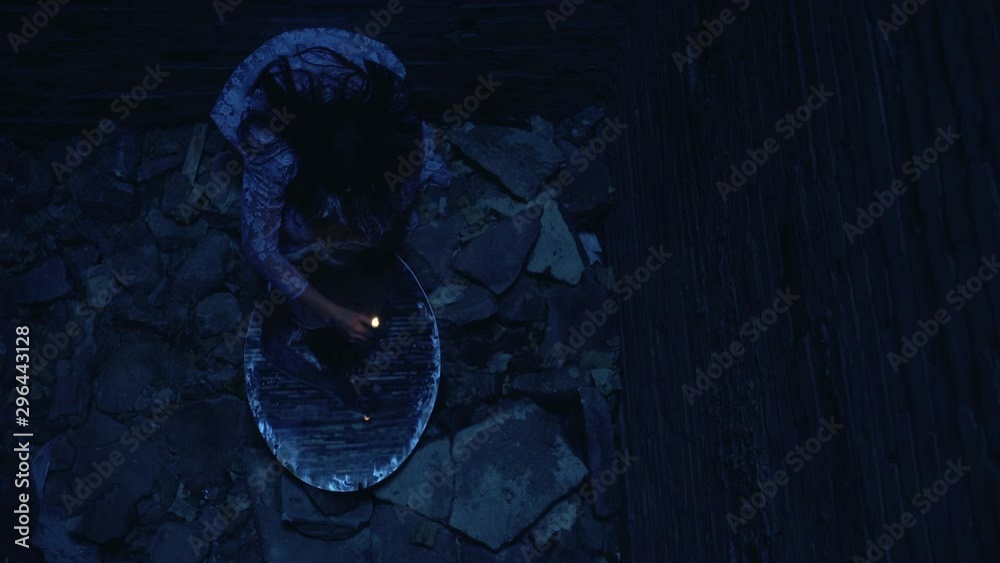 Black magic witch drawing pictogram symbol with candle wax on mirror ...