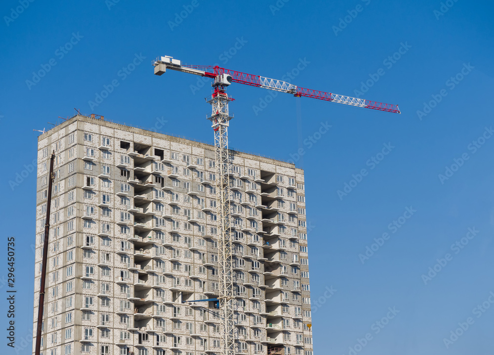 A high-rise residential building is being built. The high-rise tower ...