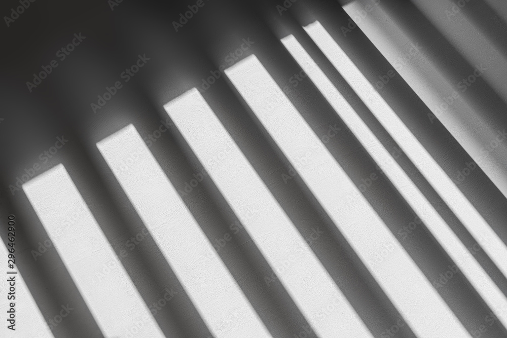 abstract shadow batten of lath and morning light on white concrete wall ...