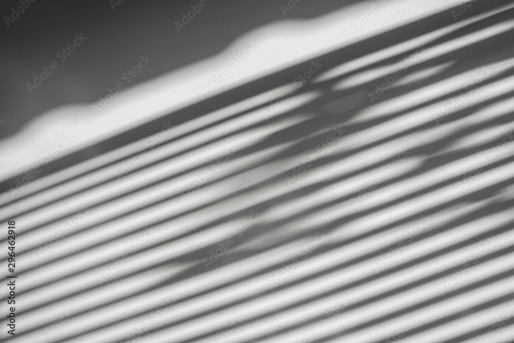 abstract shadow batten of lath and morning light on white concrete wall ...