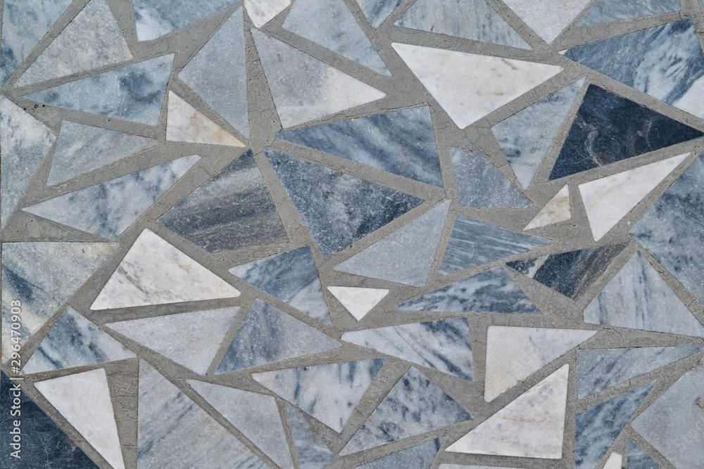 The surface of the wall or floor is made of triangular pieces of marble ...
