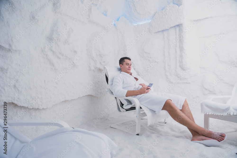 A young man is resting in the salt room, Spa treatments for men with ...