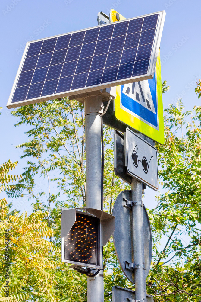 Traffic light working on solar power. Solar panel powering digital ...