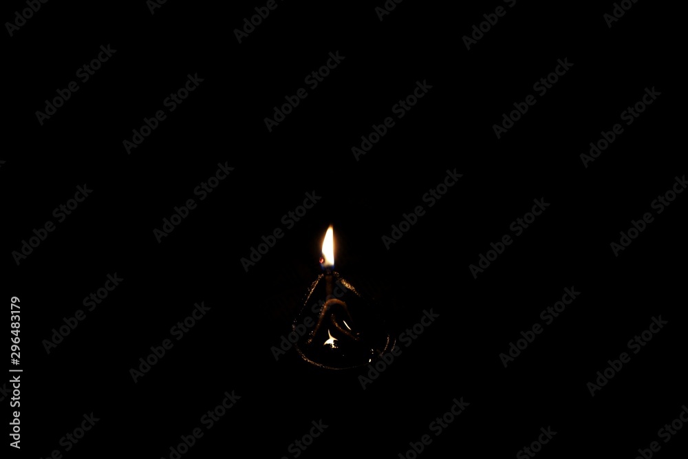 fire flame from a stone made oil lamp glowing in a dark night. The ...