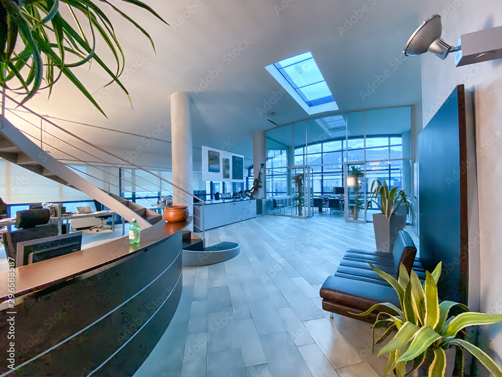 Side view of modern open space office interior with rows of computer ...