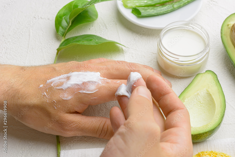 man hand care and smear moisturizing cream. spa treatments for modern ...