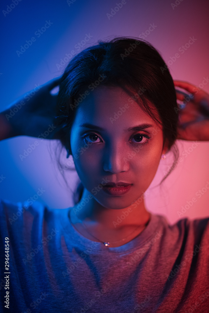 Beautiful woman face. Red and blue light color. Double light colors of ...