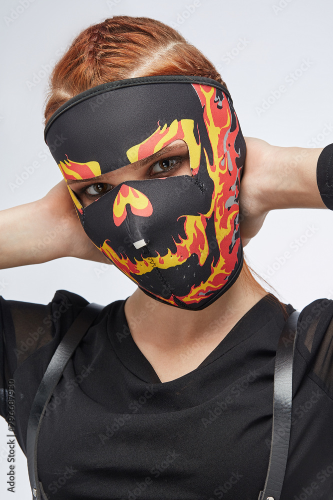 Close-up portrait of a ginger girl with three french braids, posing on ...