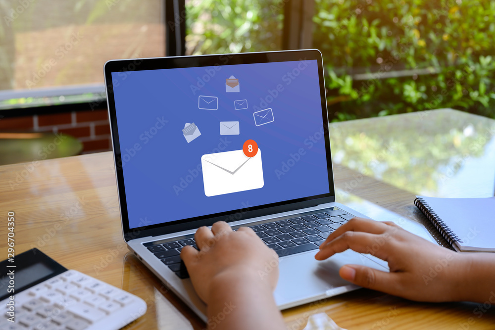 Person using a laptop computer with email communication connection ...