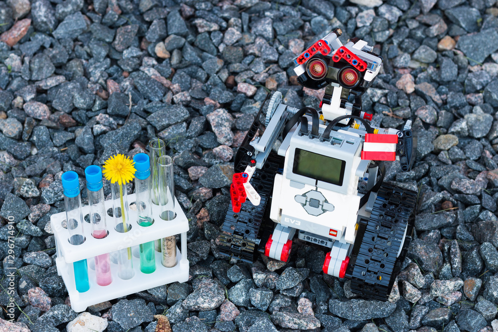 Minsk, Belarus. February, 2017: Teenager schoolboy constructs and controls the robot Walle Lego ...