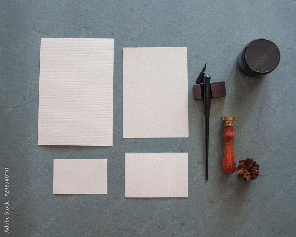 Invitations mock up on gray background. Paper blank, stamp, oblique pen ...