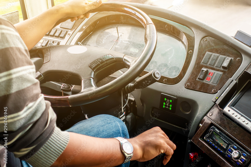The bus driver is driving in the bus cockpit while working with flare ...