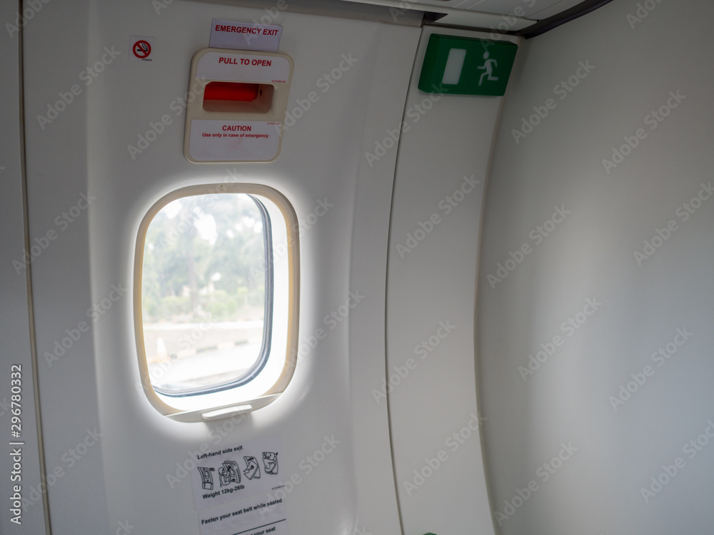 Emergency exit doors on the plane with the door opening method Stock ...