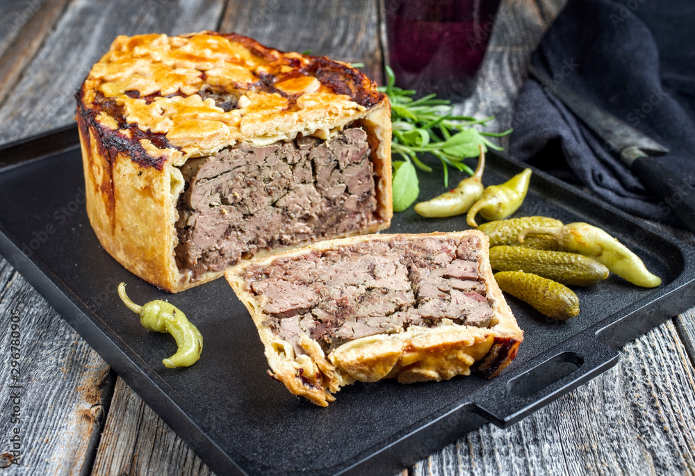 Traditional French pate en croute with goose liver as closeup with ...