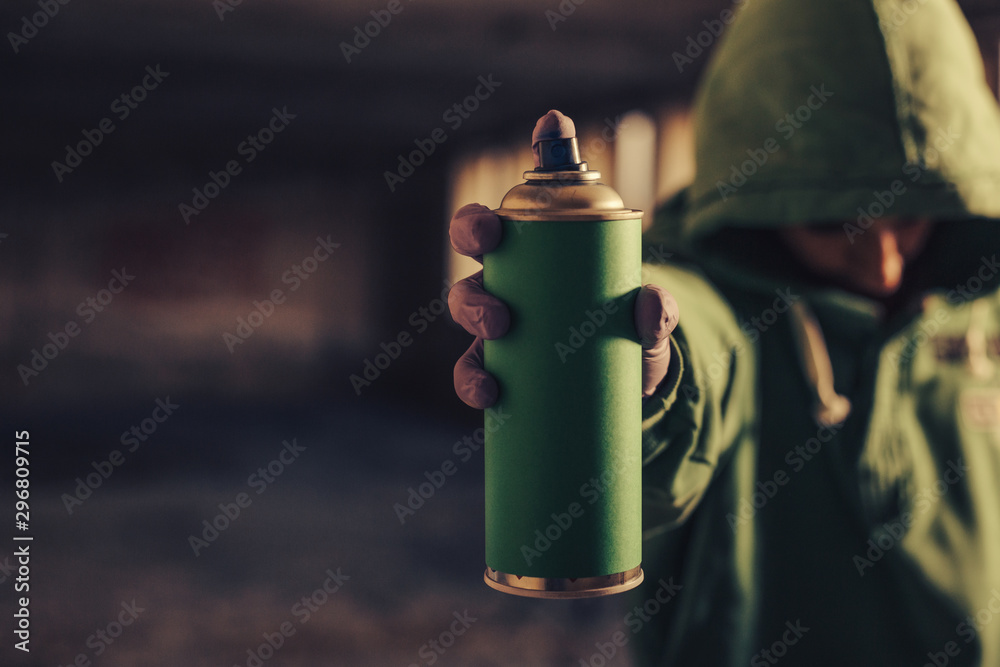 Graffiti artist pointing the spray to camera Stock Photo | Adobe Stock