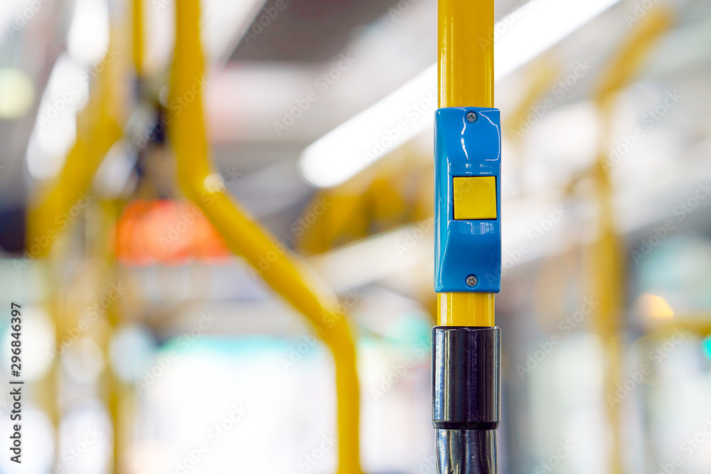 Yellow stop button for bus or tram. Press the button to request the bus ...