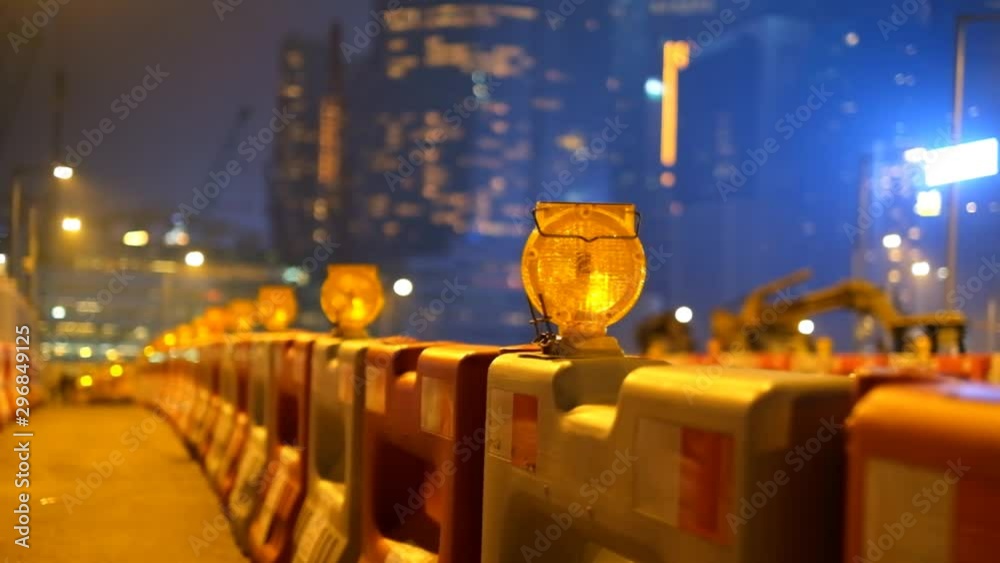 Blinking and flashing yellow warning light on the night empty city road ...