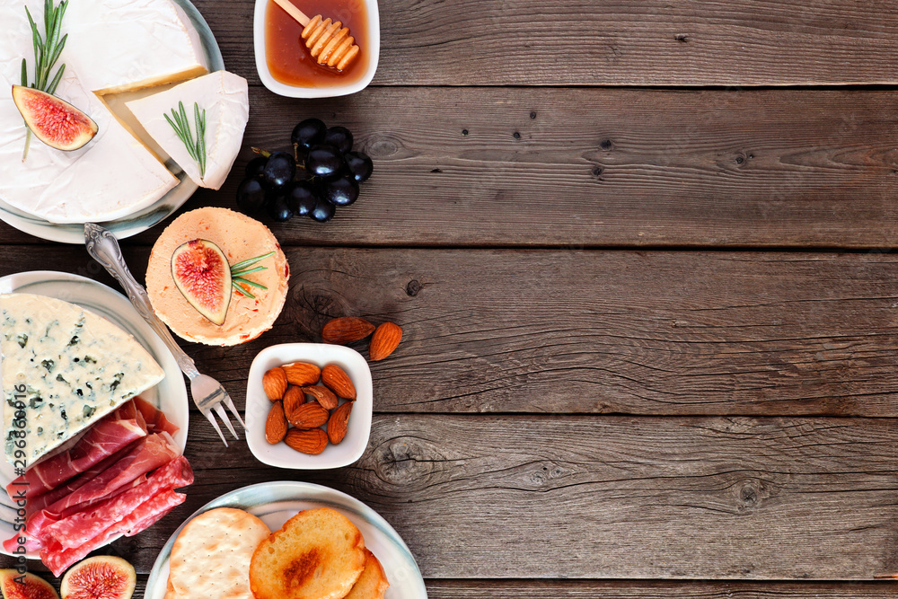 Assorted cheeses and cold cut meat appetizers. Side border, overhead ...
