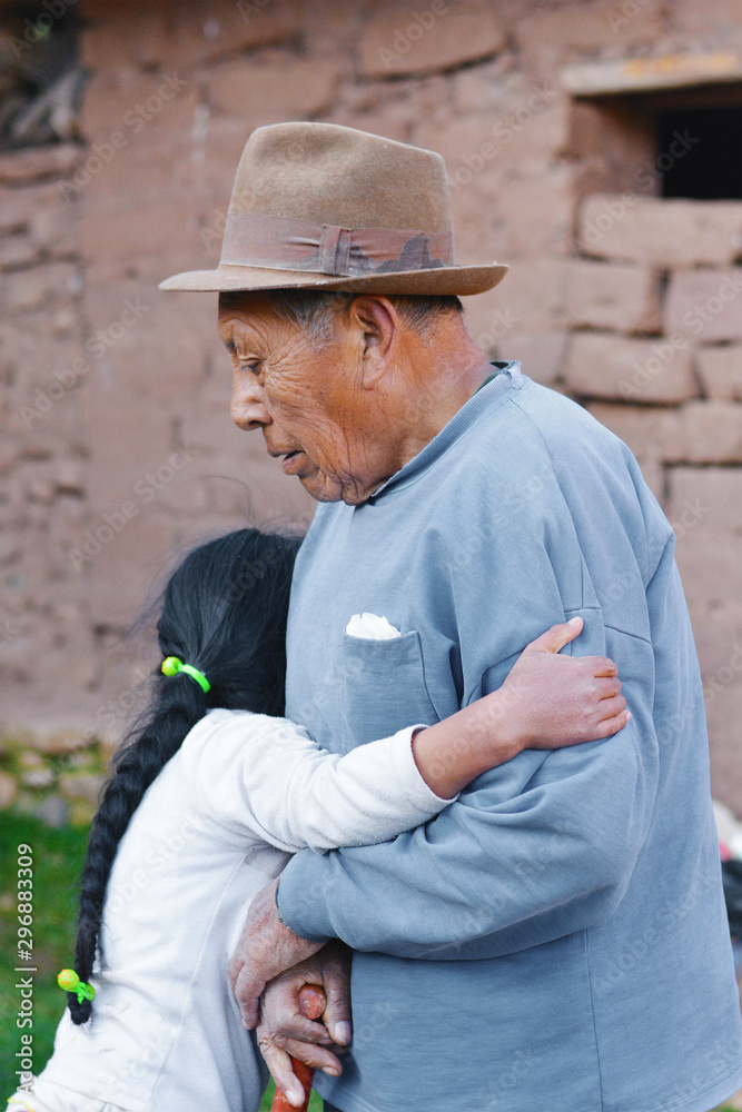 Native american little girl hugging her grandfather. Stock Photo ...