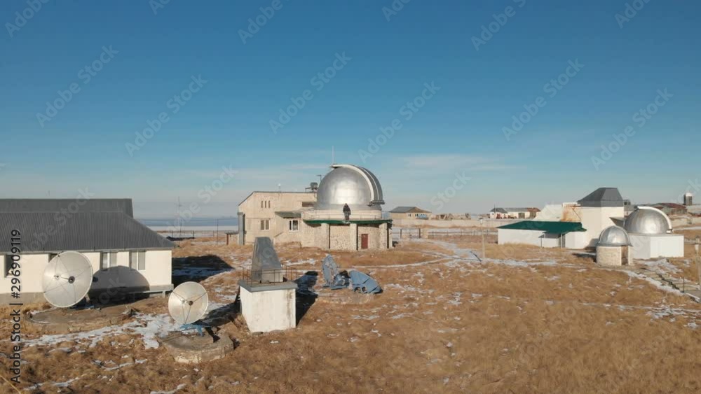 An adult male observatory worker stands on the observation deck of the ...