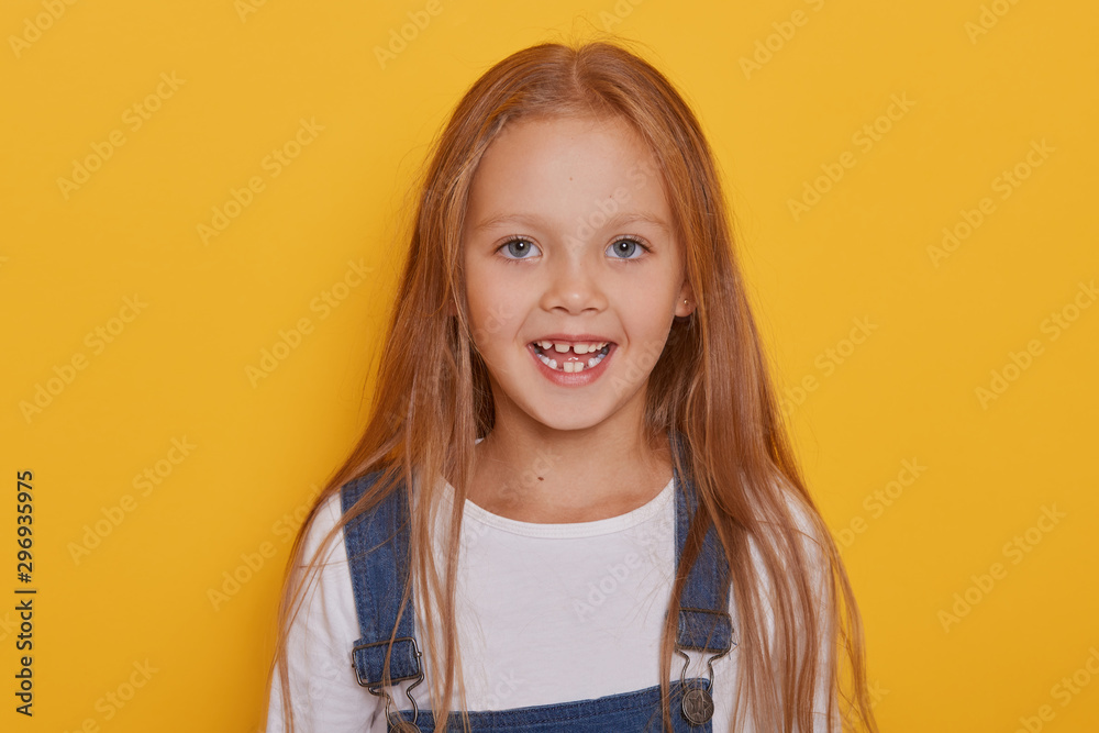 Cheerful child without front teeth posing with opened mouth and funny ...