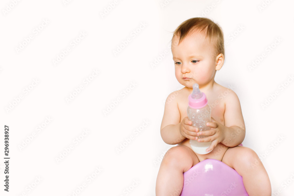 Charming photo of cute baby girl holding a boottle with baby milk and ...