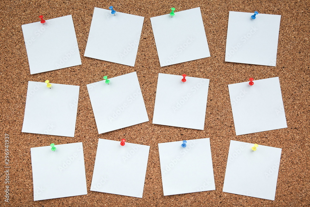 a sheets of paper are attached to the cork Board with a push-buttons ...