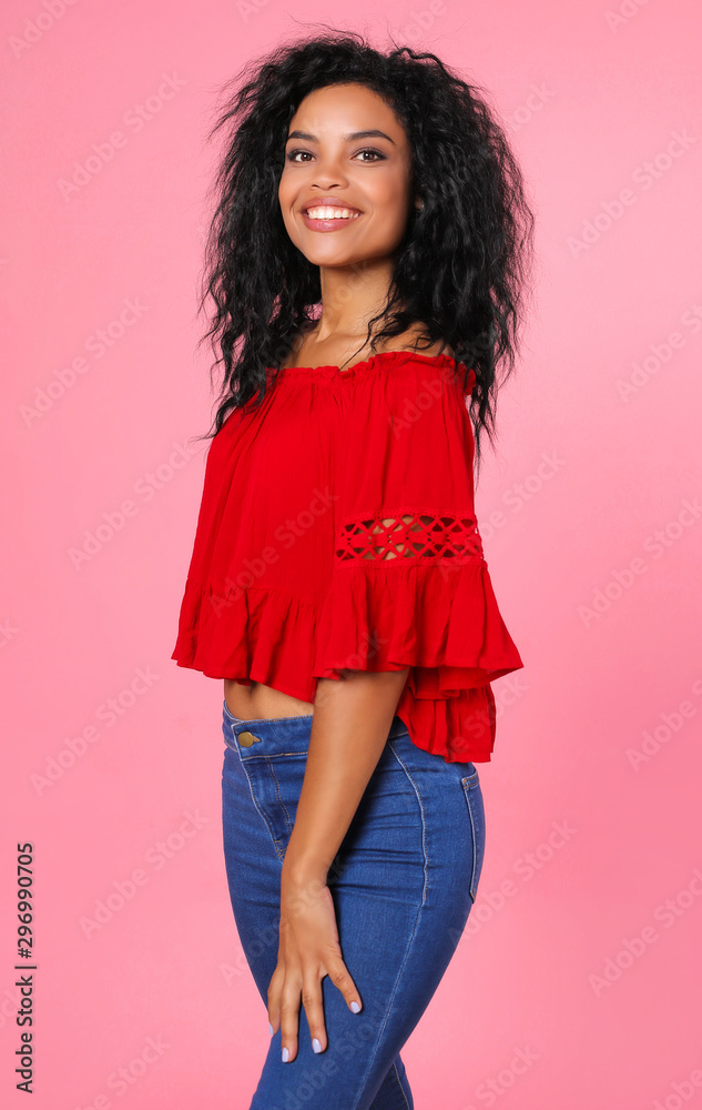 Lady in red. Gorgeous Afro-American woman in a red blouse and blue ...